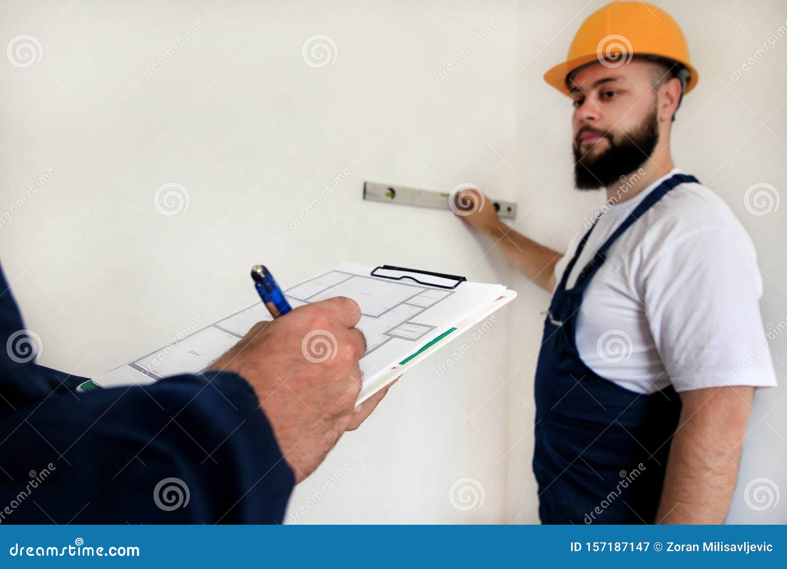 Engineer with His Colleague, Construction Worker is Measuring Wall ...