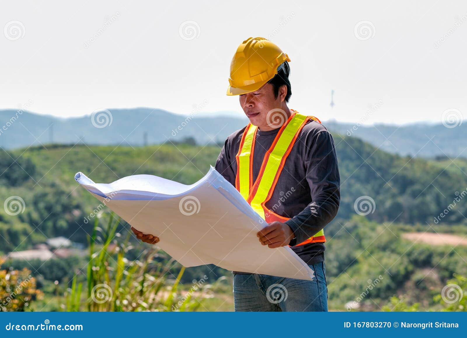 Engineer Hold the Construction Paper Plan and Look To it in Front of ...