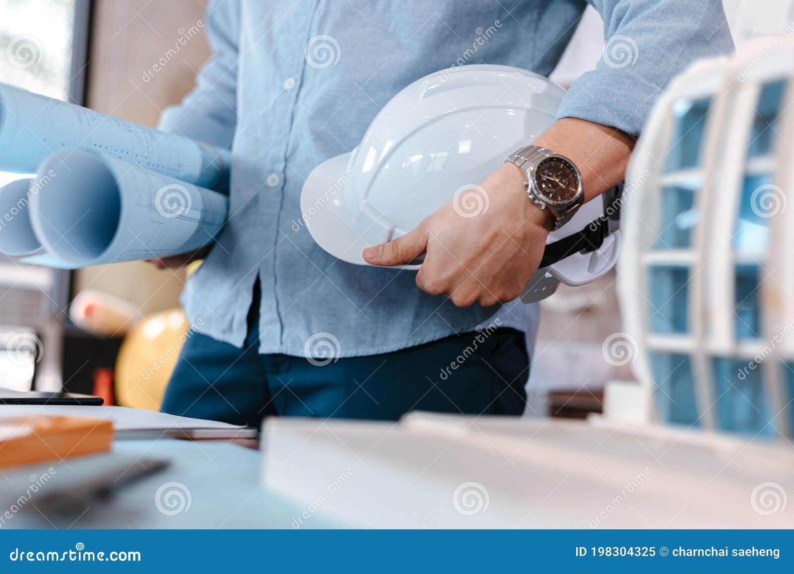 Engineer Hold Engineer Drawing Design Blueprints and Safety Helmet in ...