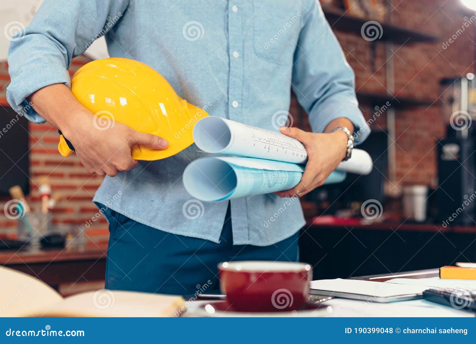 Engineer Hold Engineer Drawing Design Blueprints and Safety Helmet in ...