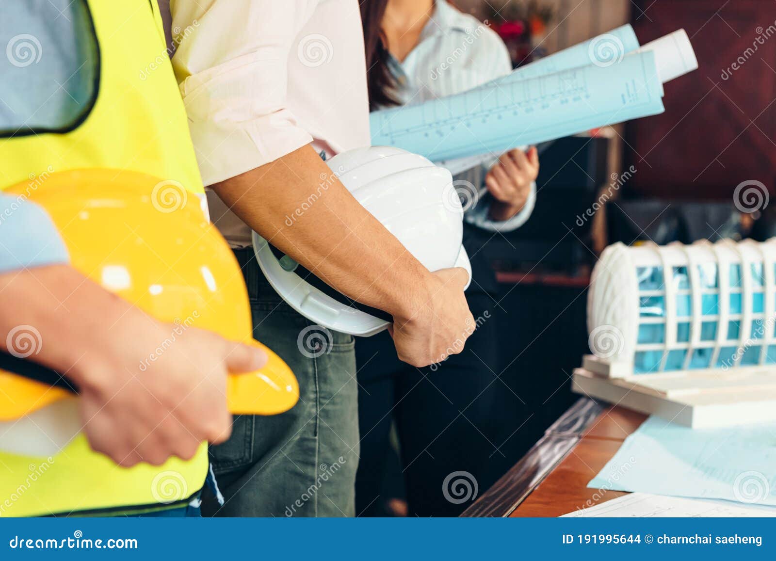 Engineer Hold Engineer Drawing Design Blueprints and Safety Helmet in ...