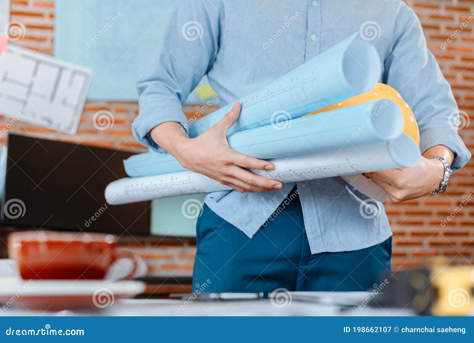 Engineer Hold Engineer Drawing Design Blueprints and Safety Helmet in ...