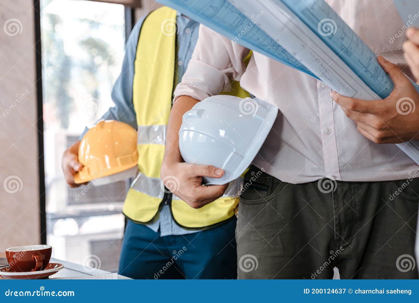 Engineer Hold Engineer Drawing Design Blueprints and Safety Helmet in ...