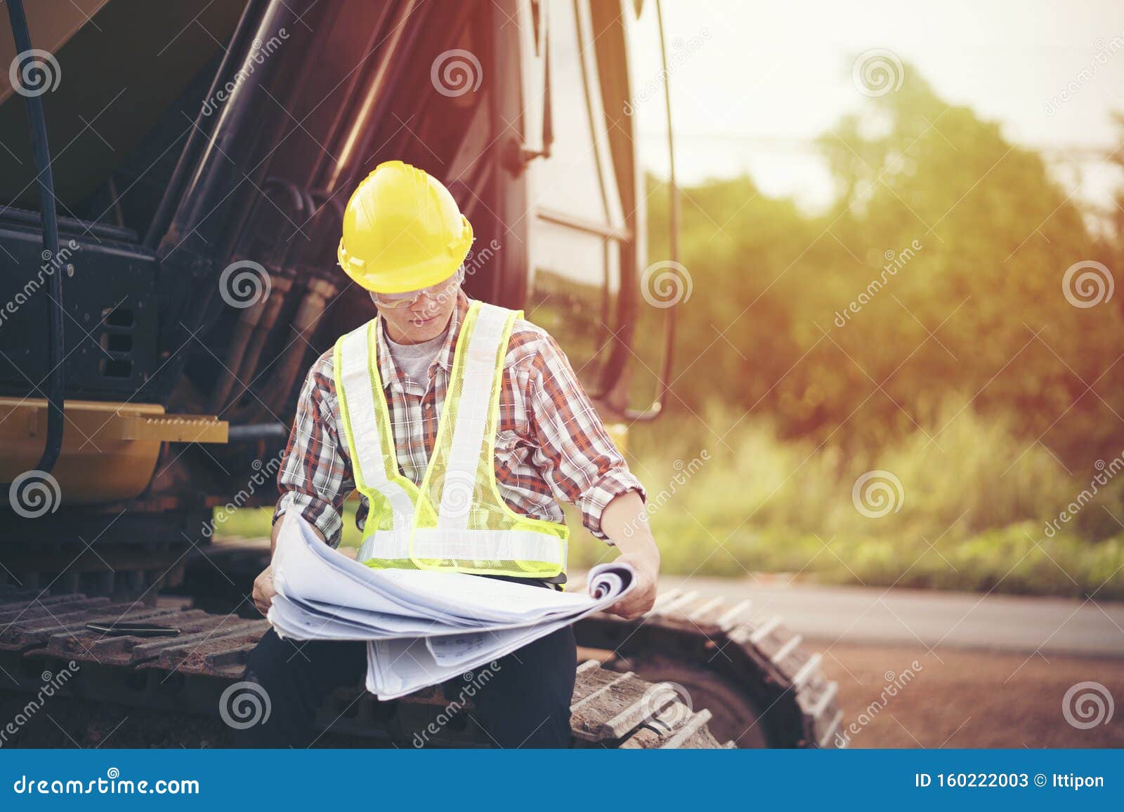 Engineer Holding Blueprint with Backhoe Stock Image - Image of ...