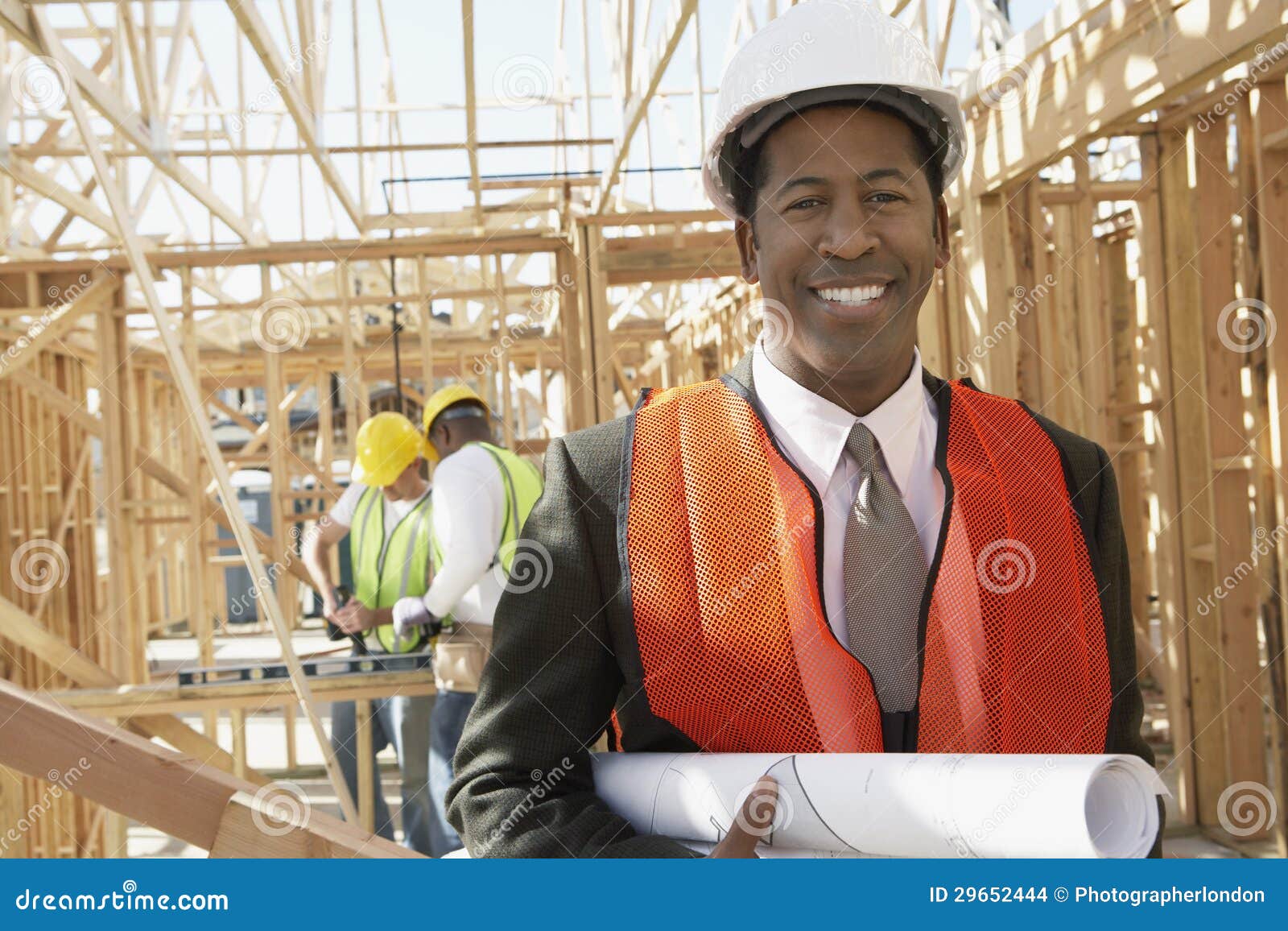 Engineer Holding Blueprint at Construction Site Stock Photo - Image of ...