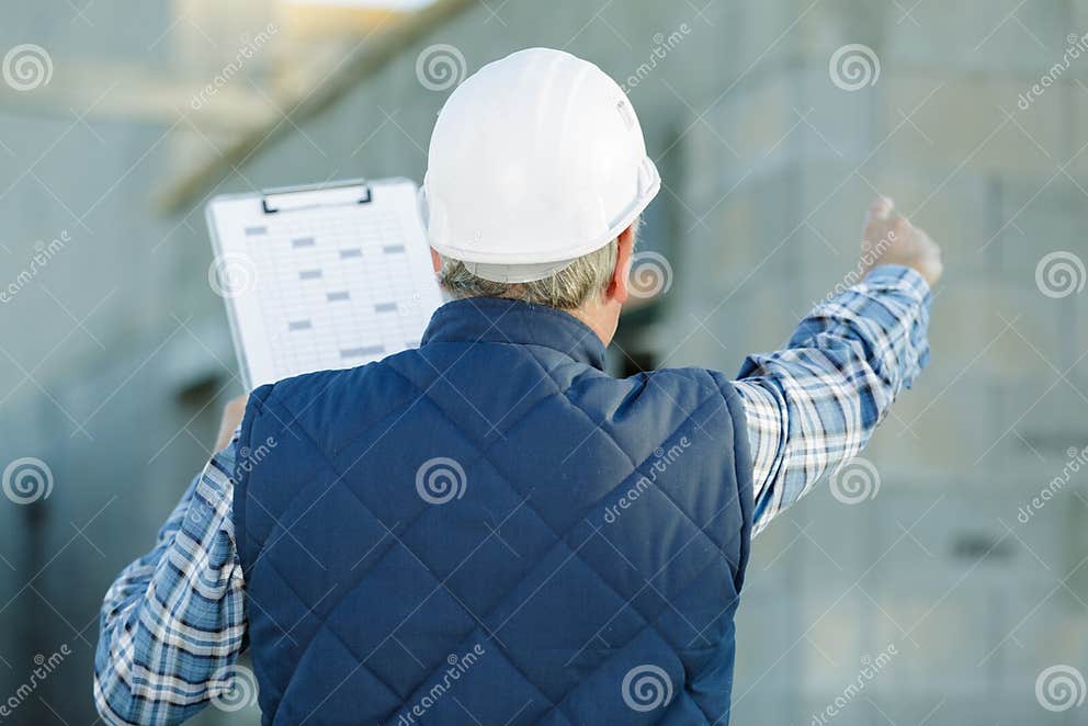 Engineer Holding Clipboard and Pointing To Something Stock Image ...
