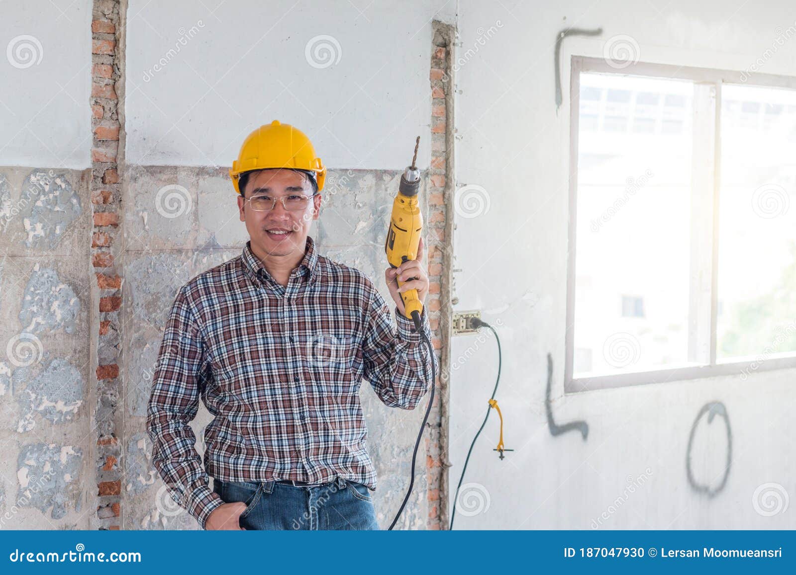 The Engineer Holding the Electric Drill and Working at Construction ...