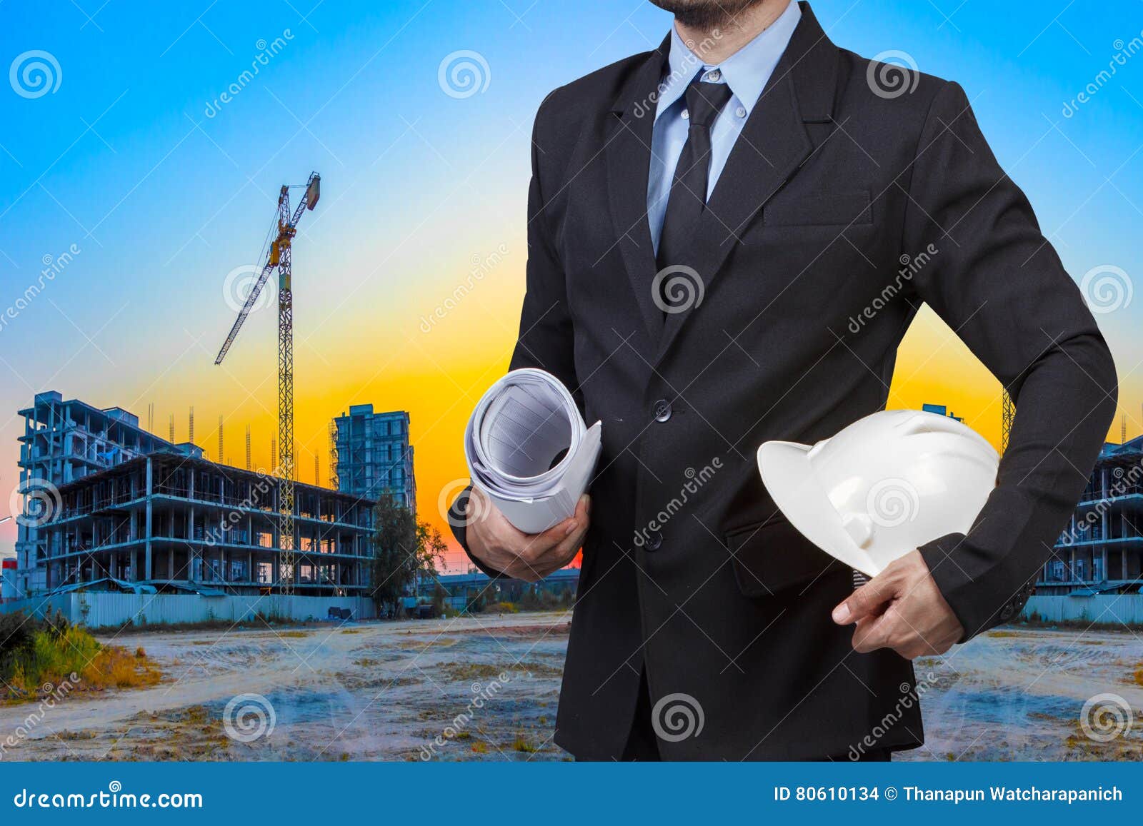 Engineer Holding Hardhat and Blueprint at Building Construction Stock ...