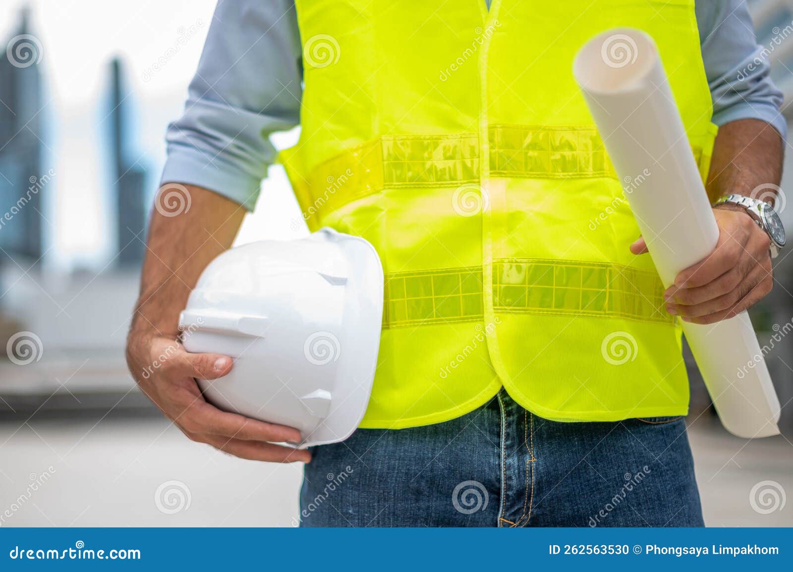 Engineer Holding Hardhat and Floor Plan Wearing Yellow Vest and ...