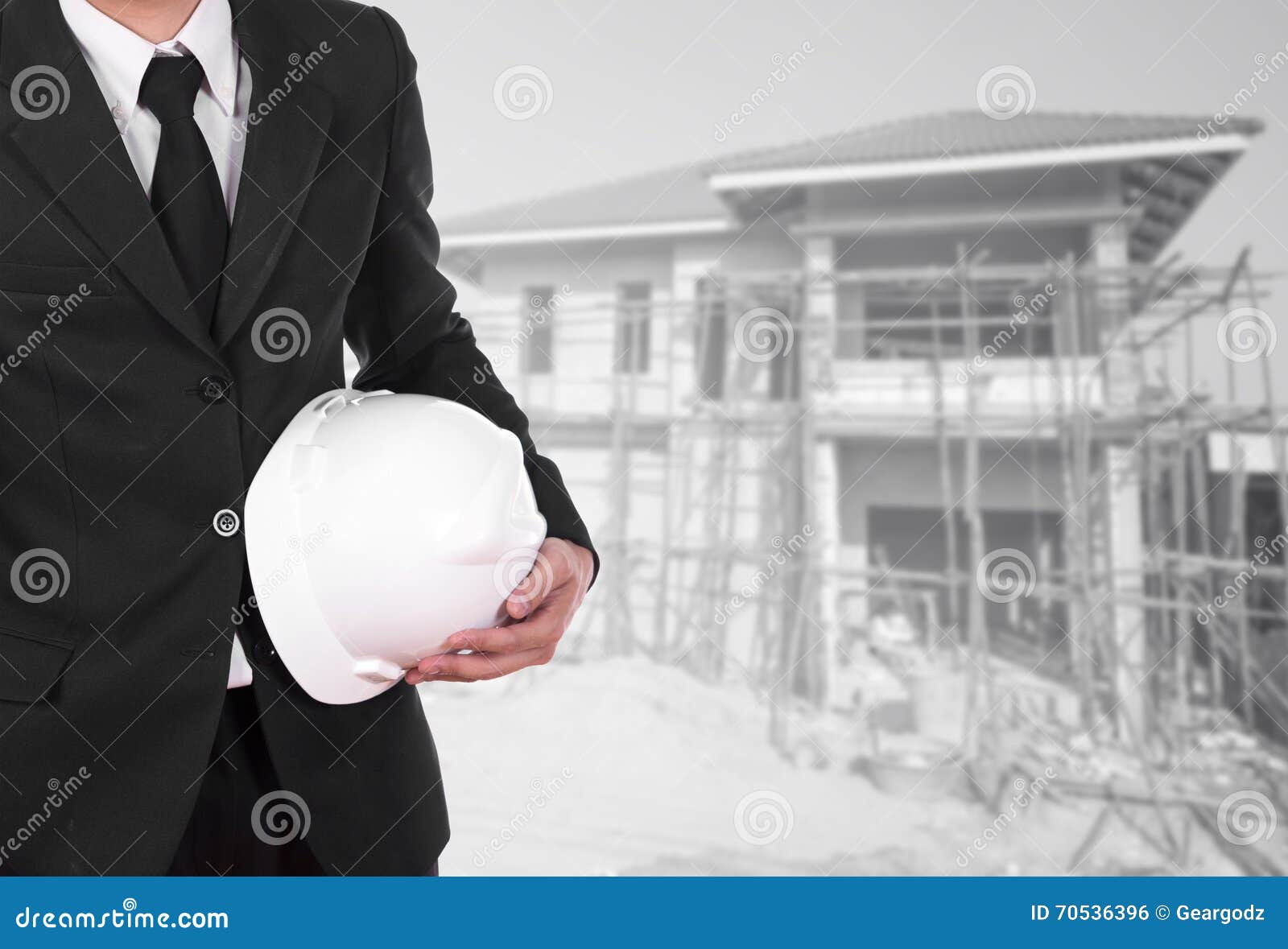 Engineer Holding Helmet with House Construction Background Stock Photo ...