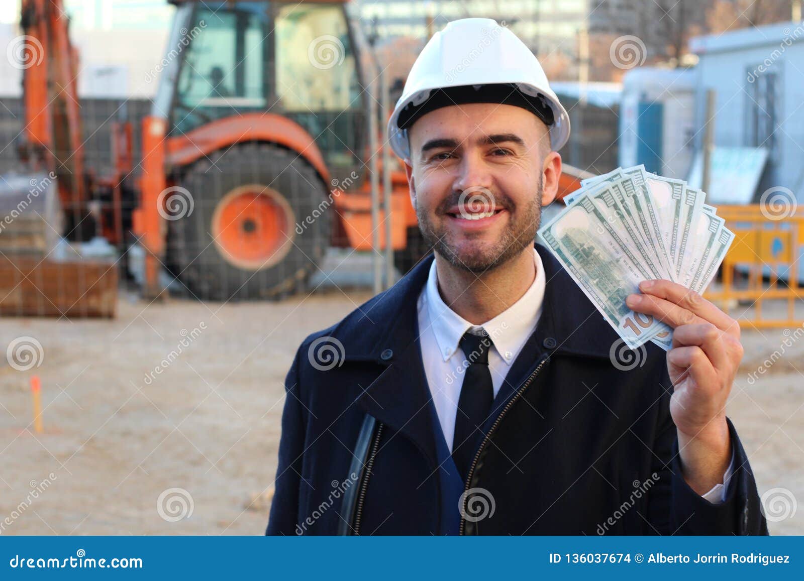 Engineer Holding Money in Construction Site Stock Photo - Image of ...