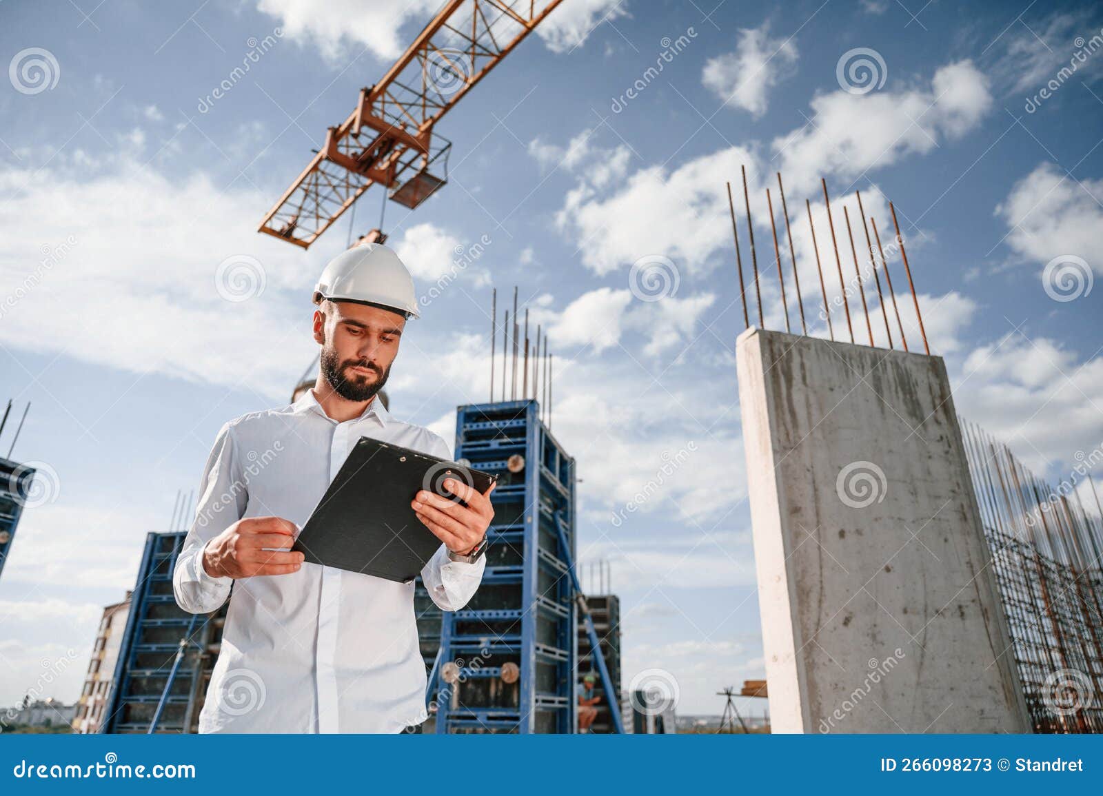 Engineer is Holding Notepad. Man in Uniform is Working on the ...