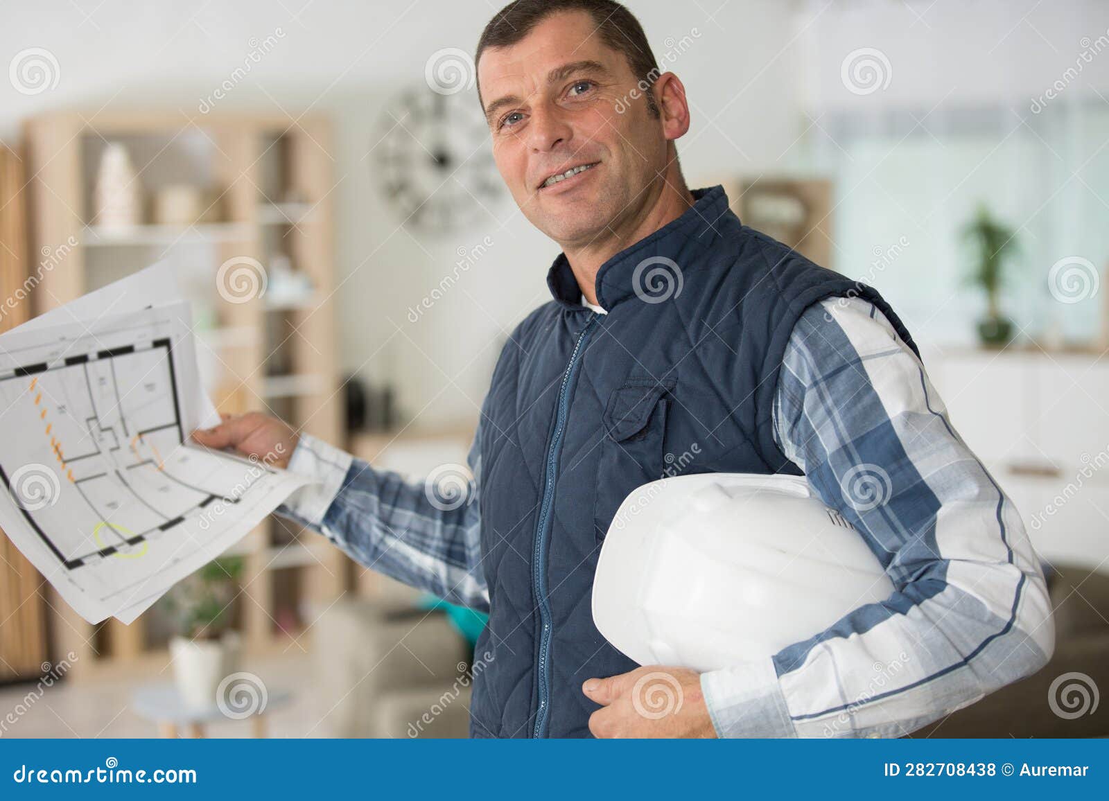 Engineer Holding Plan while Smiling at Camera Stock Photo - Image of ...