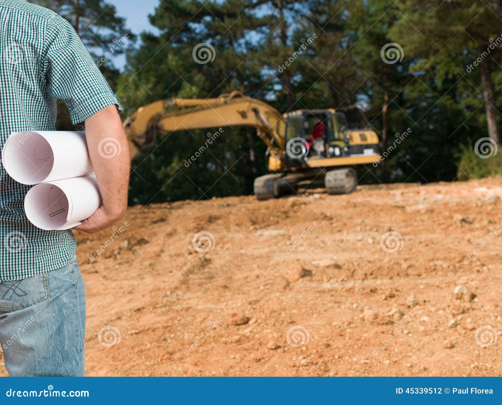 Engineer Holding Plans on Construction Site Stock Photo - Image of ...