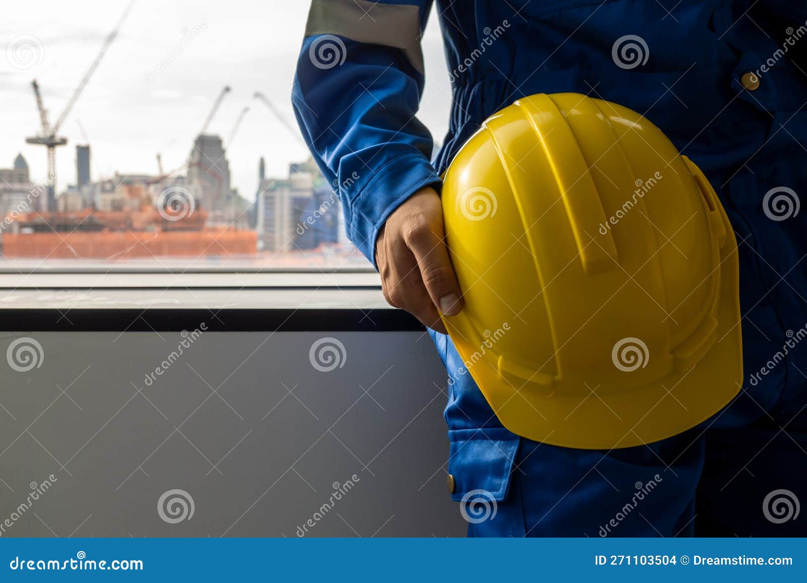 Engineer Holding Yellow Helmet with Construction Building Site ...