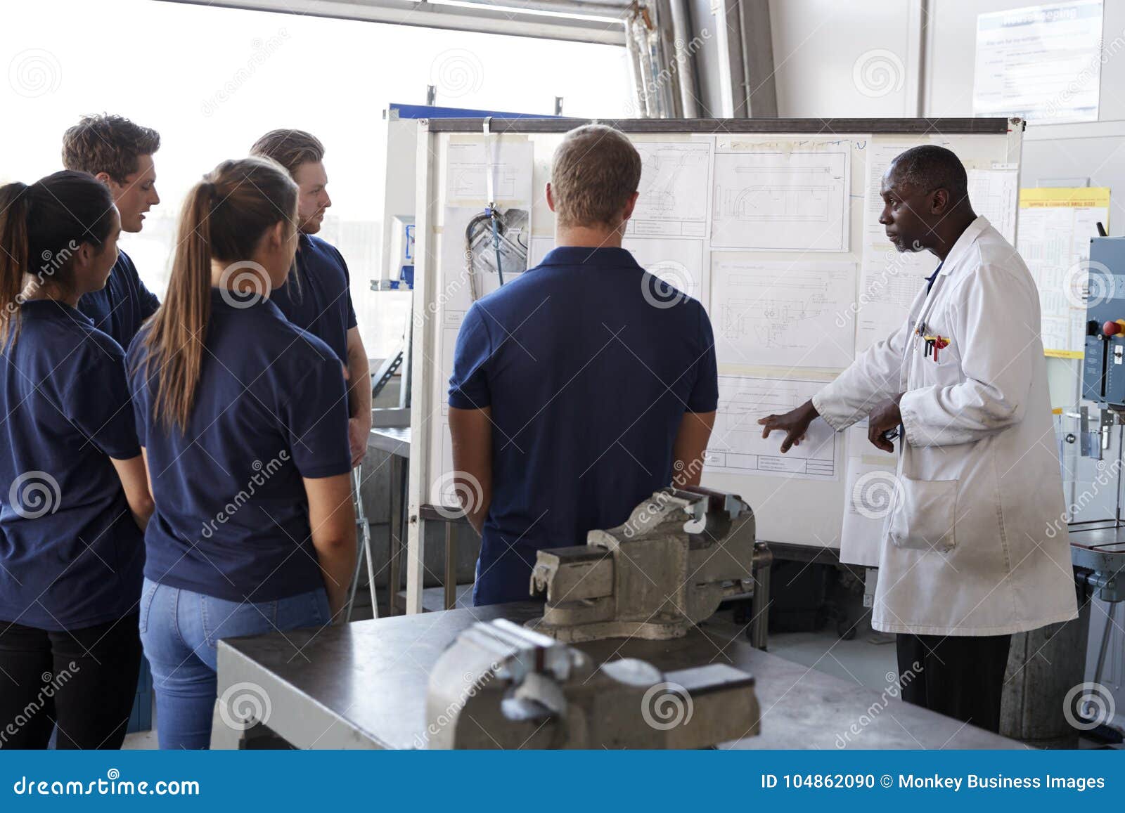 Engineer Instructing Apprentices at a Whiteboard, Close Up Stock Photo ...