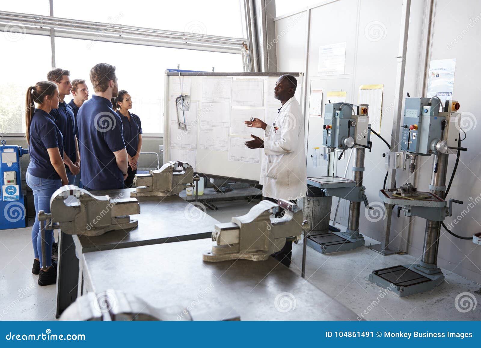 Engineer Instructing Apprentices at a Whiteboard, Side View Stock Image ...
