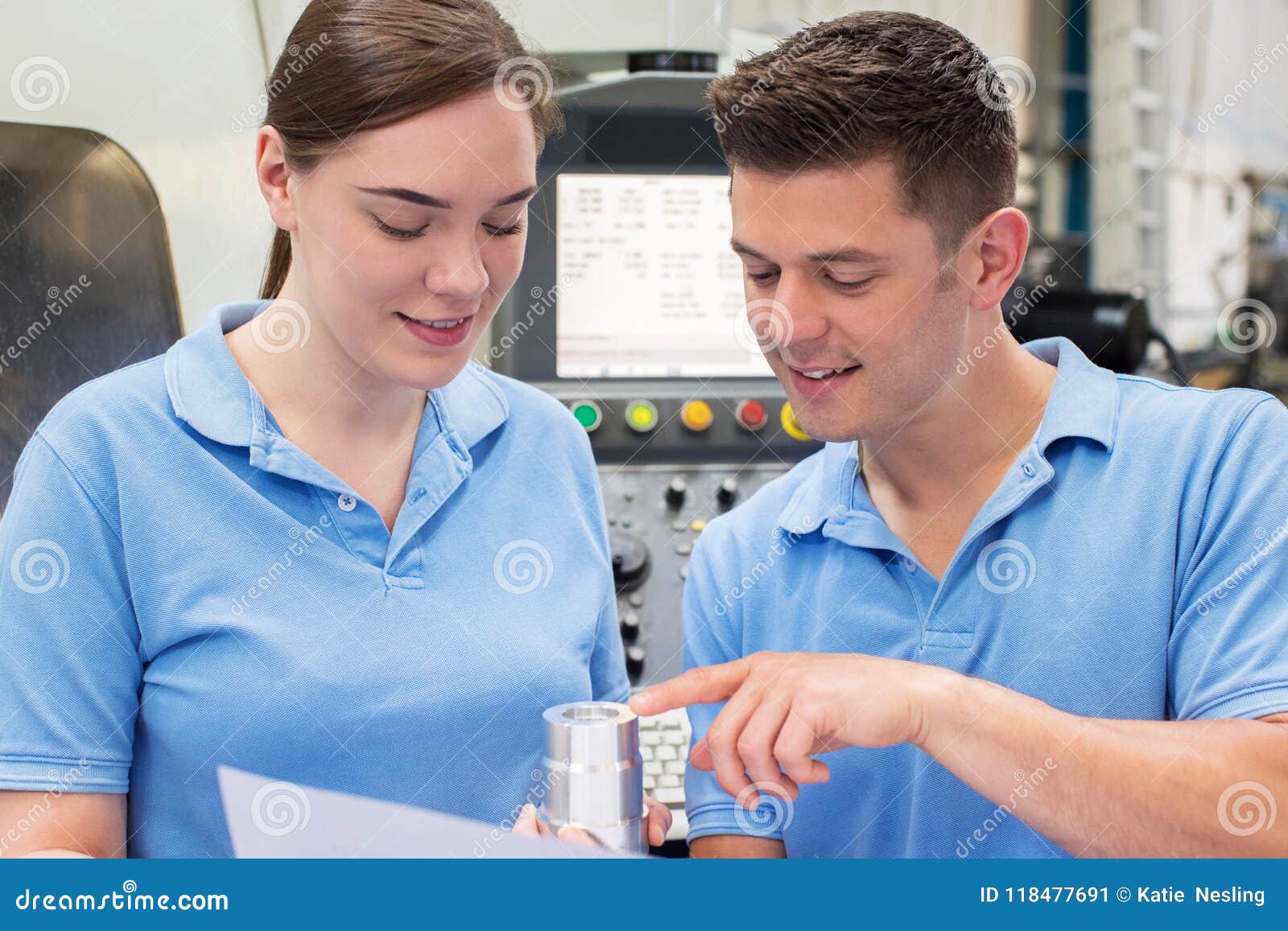 Engineer Instructing Female Apprentice on Use of CNC Machine Stock ...