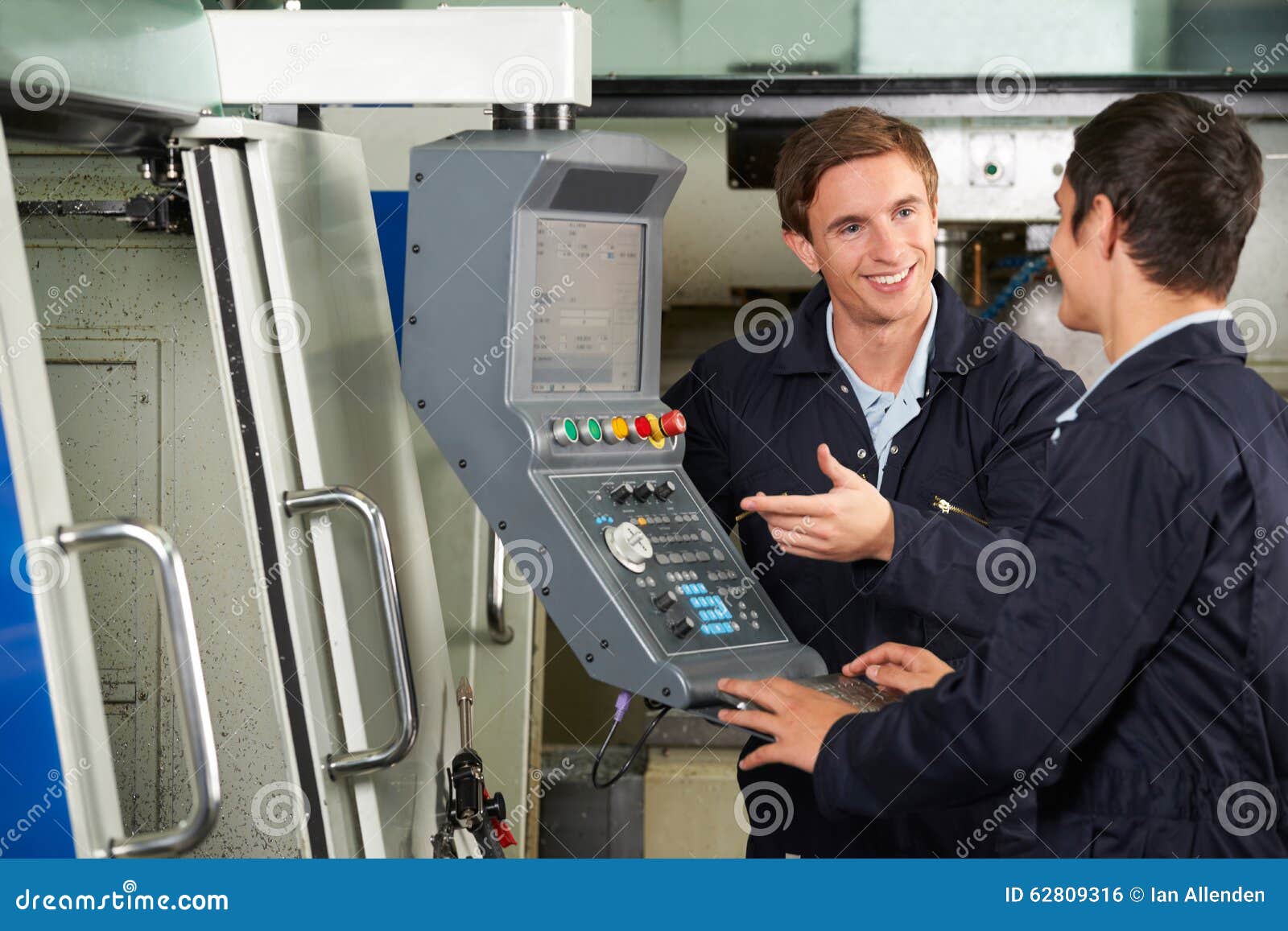 Engineer Instructing Trainee on Use of Computerized Cutting Mach Stock ...