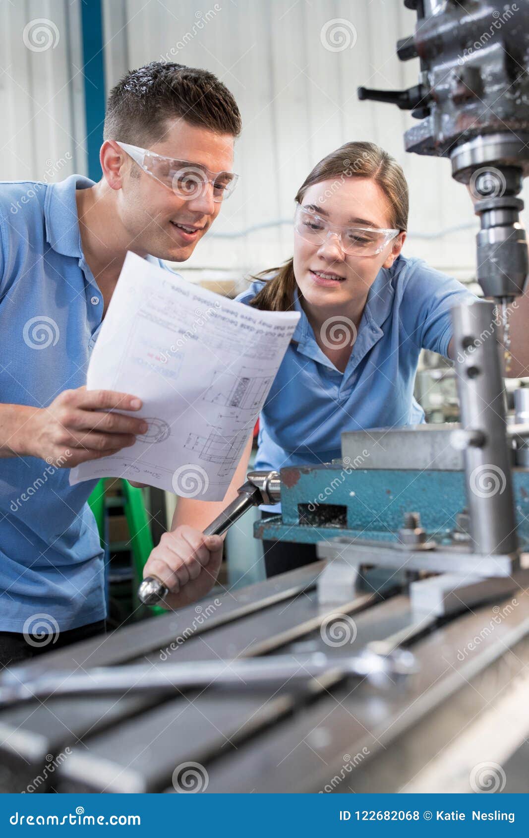 Engineer Instructing Female Apprentice on Use of Drill Stock Photo ...