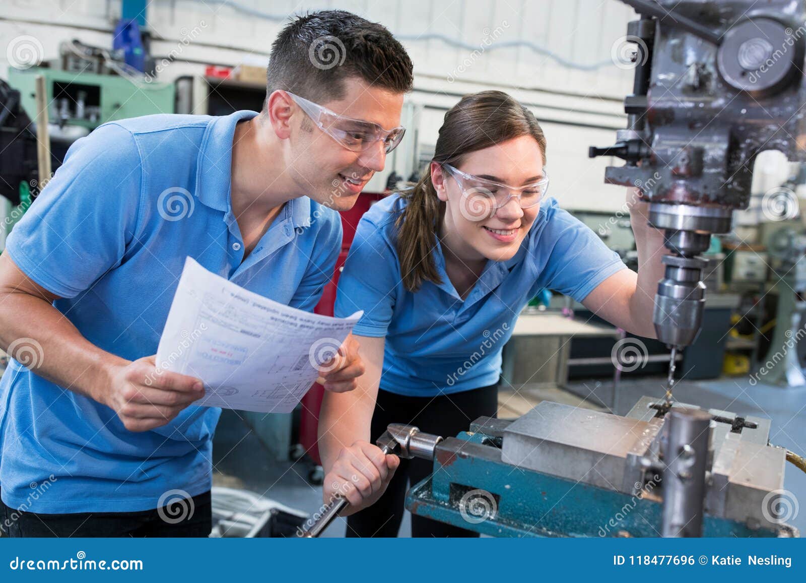 Engineer Instructing Female Apprentice on Use of Drill Stock Photo ...