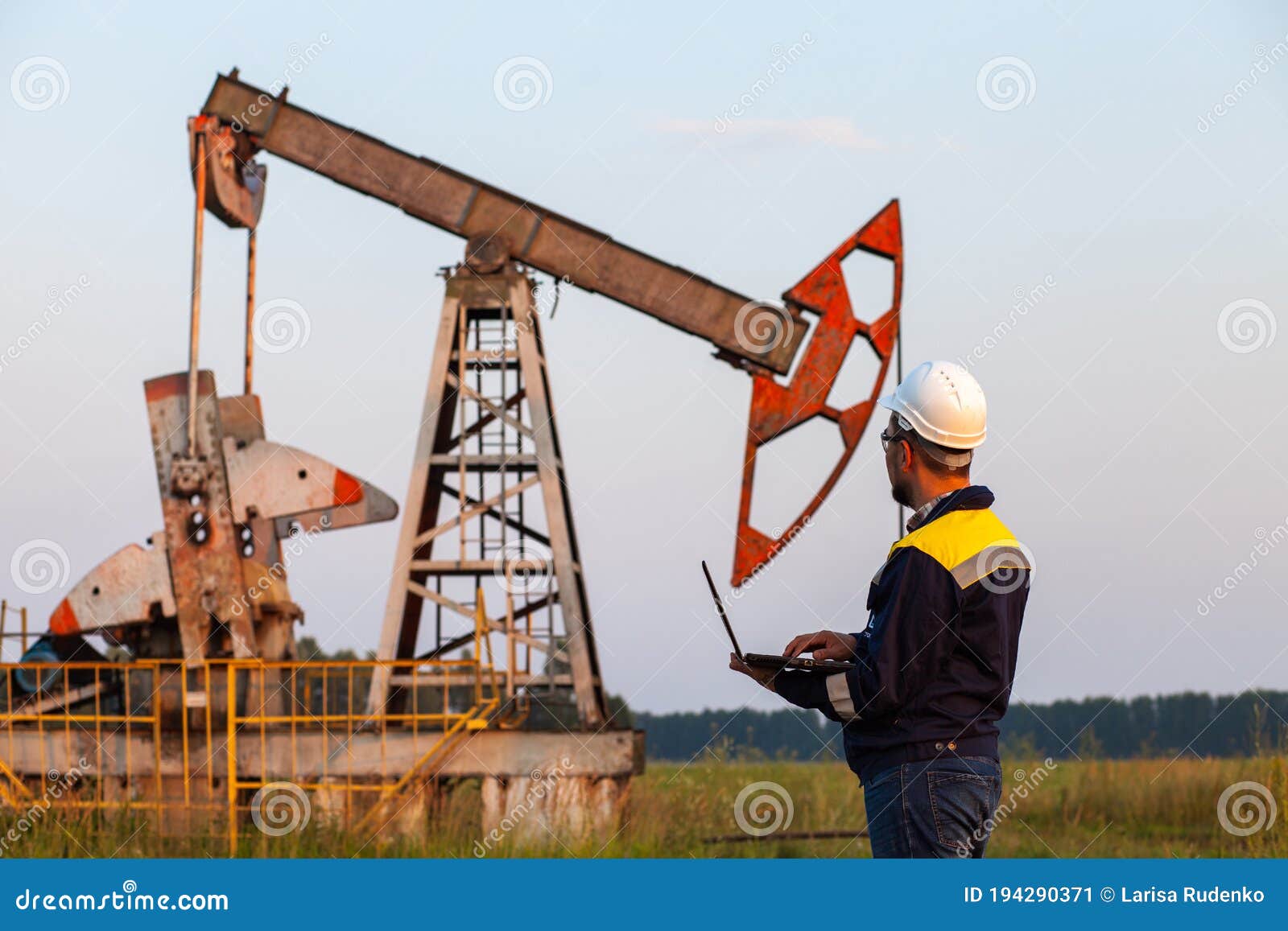 Engineer with a Laptop on the Background of an Oil Pump Stock Image ...