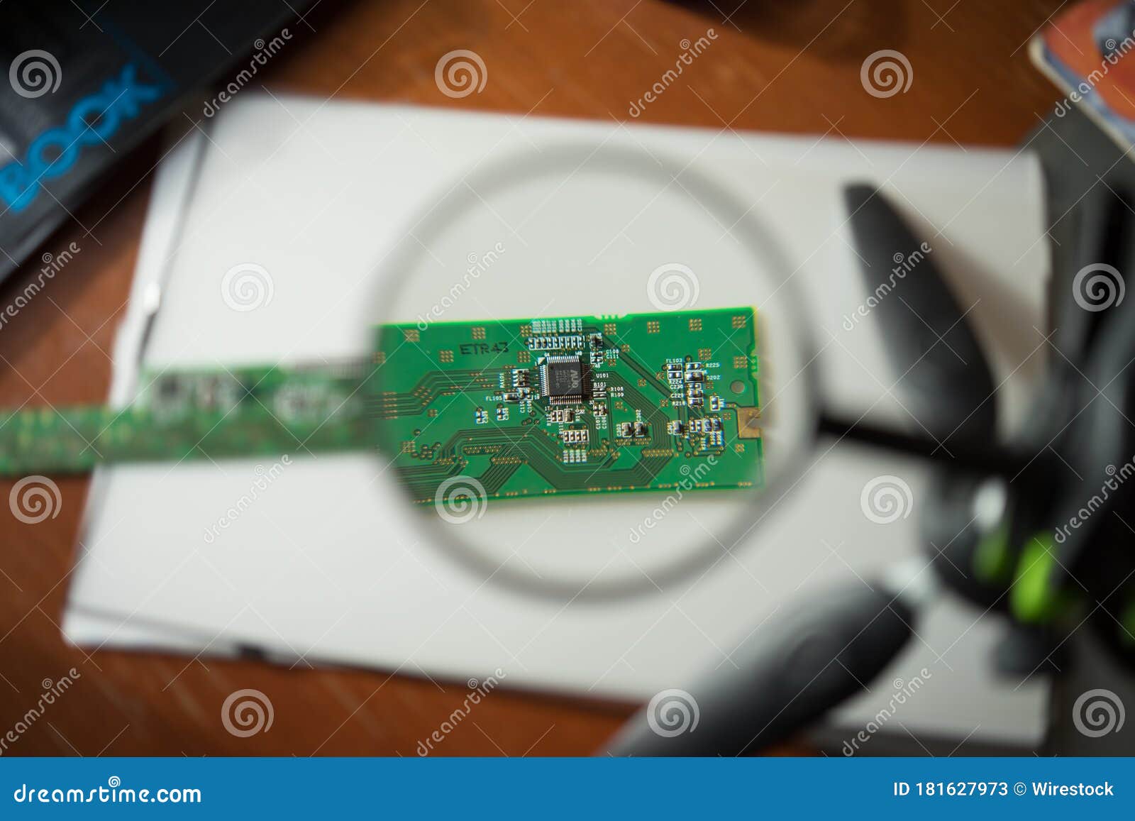 Engineer Looking at a Circuit Board through a Magnifying Glass ...