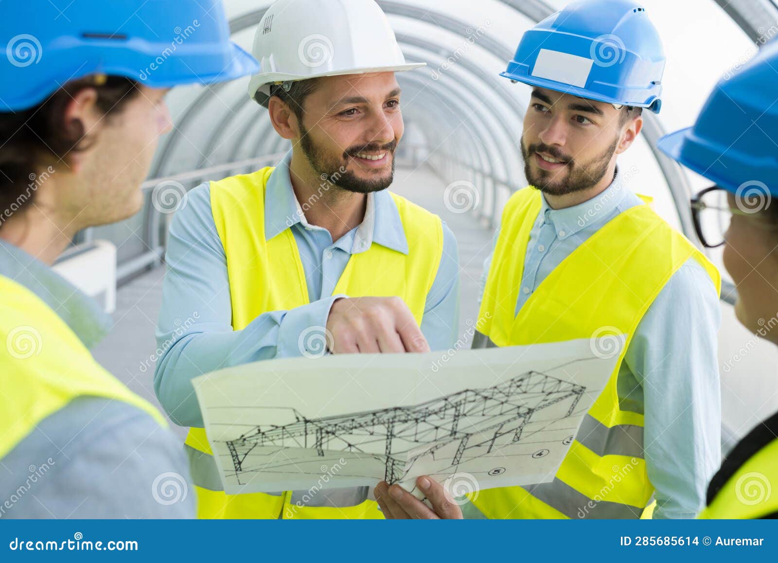 Engineer Looking Over Building Plans with Construction Workers Stock ...
