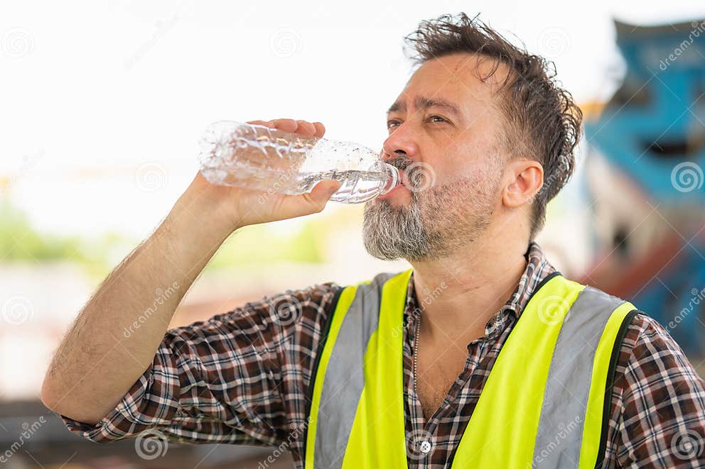 Engineer Man Drinking Water at the Precast Factory Site, Worker Man ...