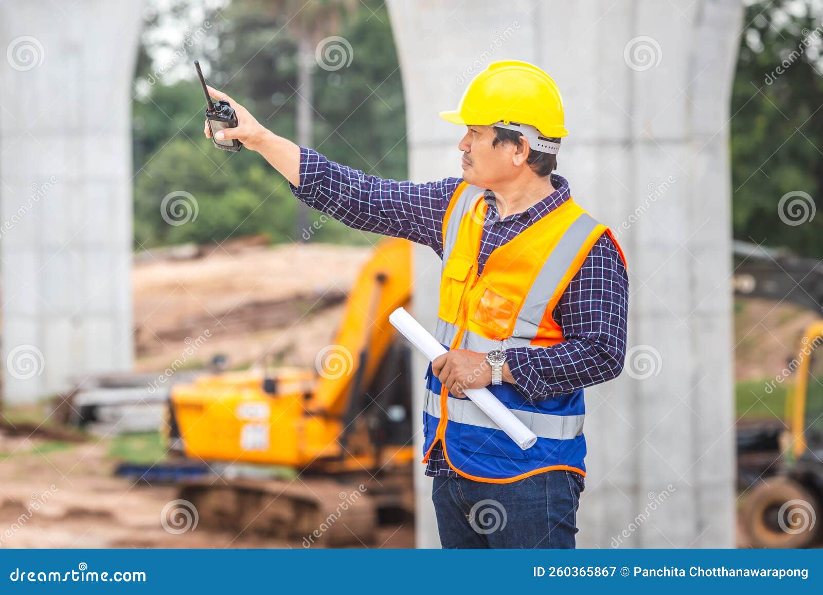 Engineer Man in Hardhat with Two-Way Radio at the Infrastructure ...