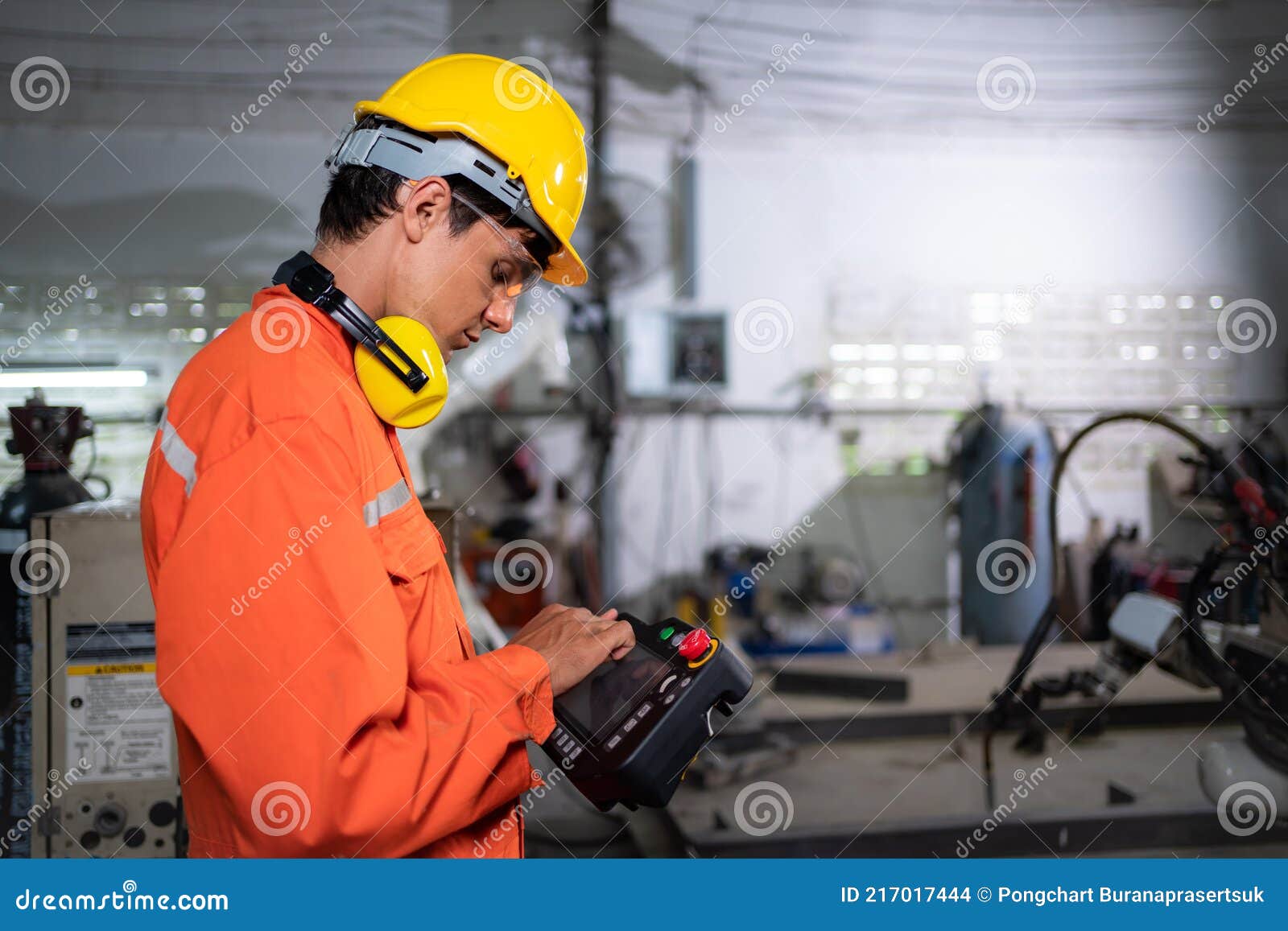 Engineer Man in Uniform Using Remote Control Robotic Arm Machine To ...