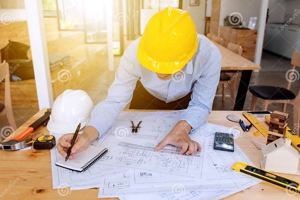 Engineer Man Working in the Office, Drawing the Construction Project ...