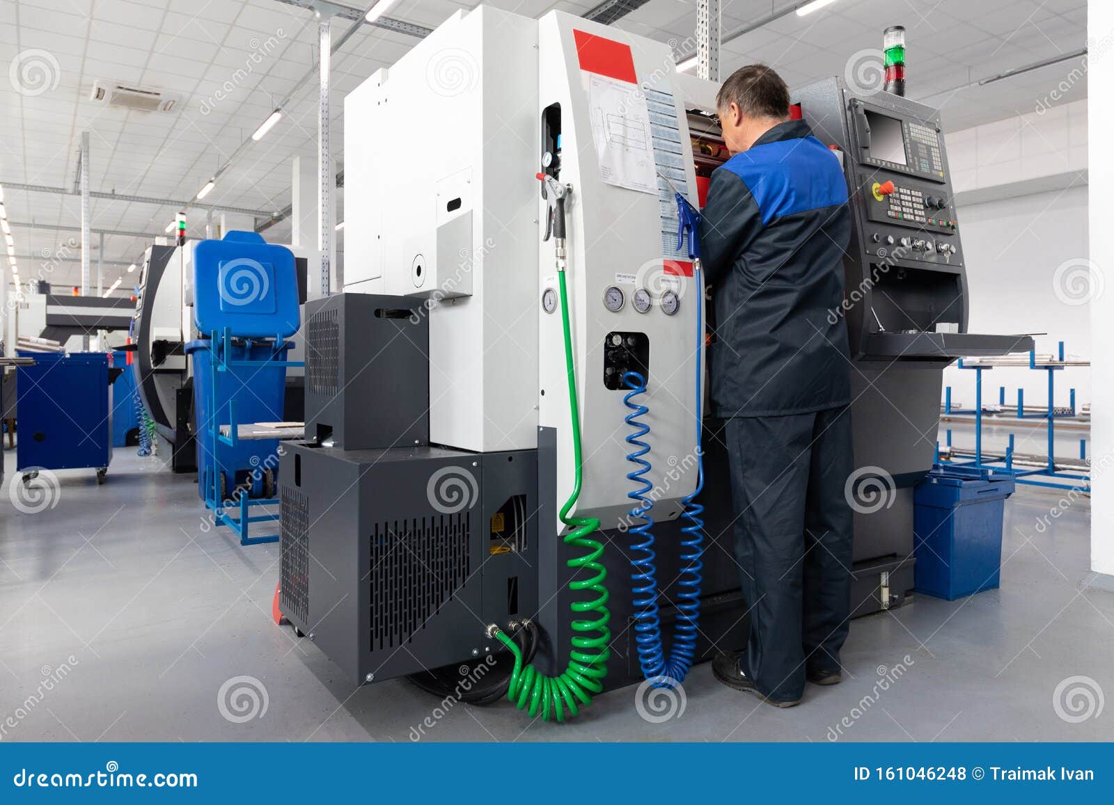Engineer of Metal Processing Equipment before Panel with Buttons Stock ...