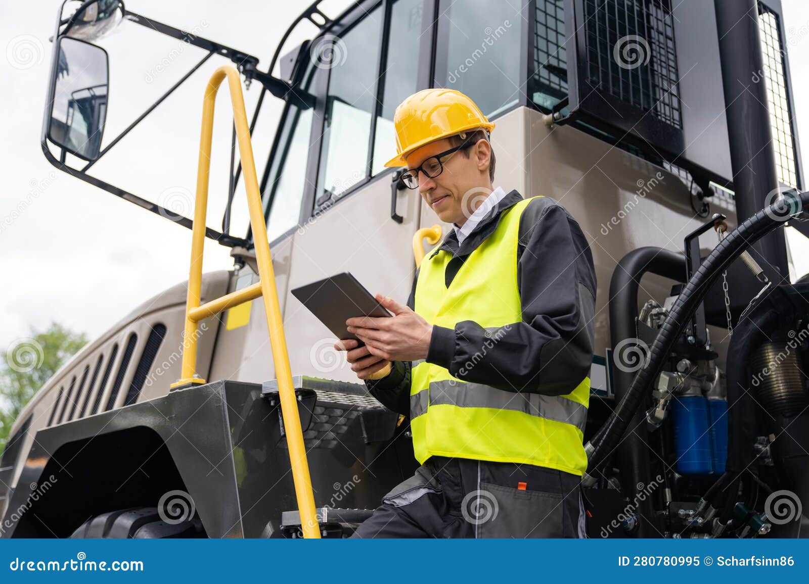 Engineer with mining truck stock image. Image of tablet - 280780995