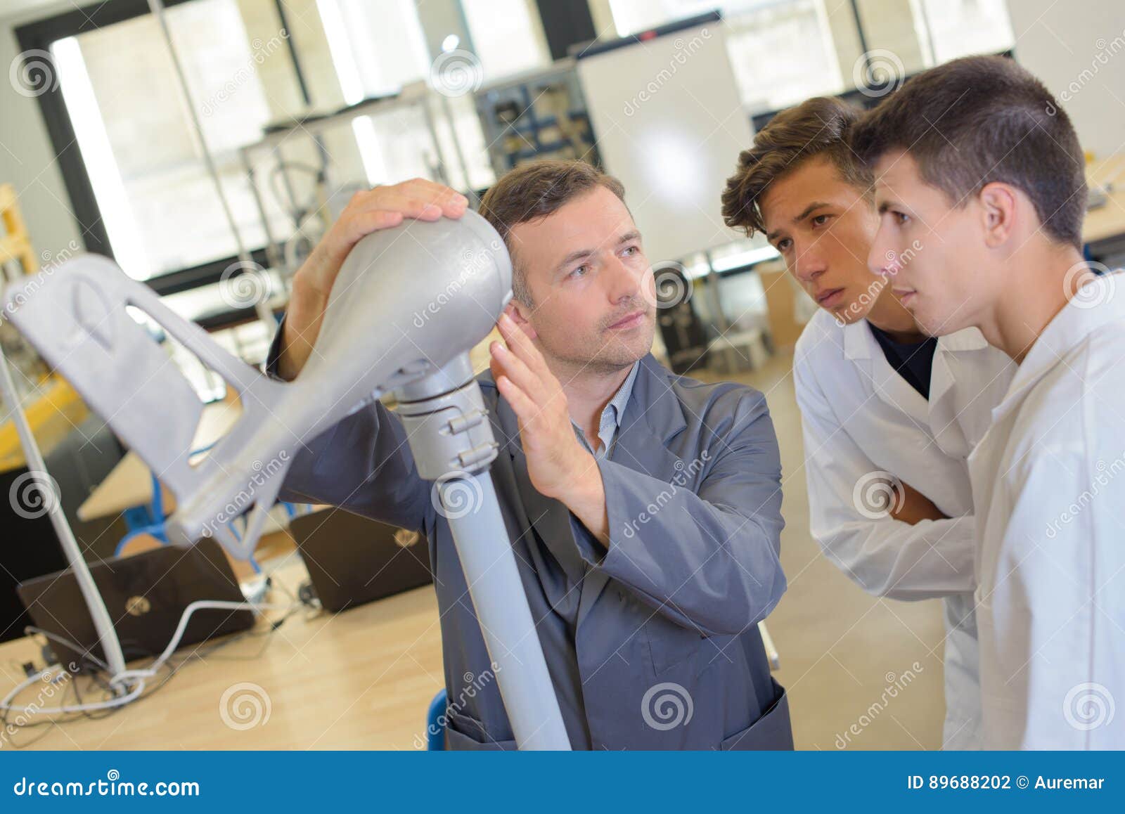 Engineer with Model Aircraft Tail and Two Students Stock Photo - Image ...