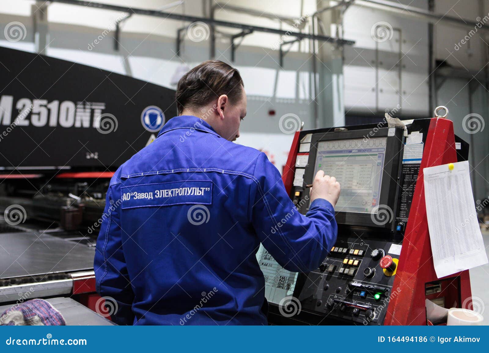 An Engineer at the Monitor of a Numerically Controlled Machine Controls ...