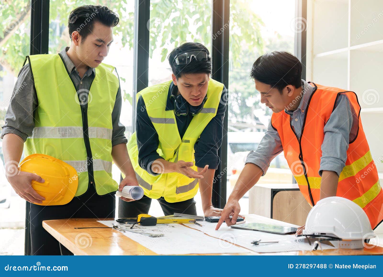 Engineer People Meeting Working and Pointing at a Blueprint in Office ...