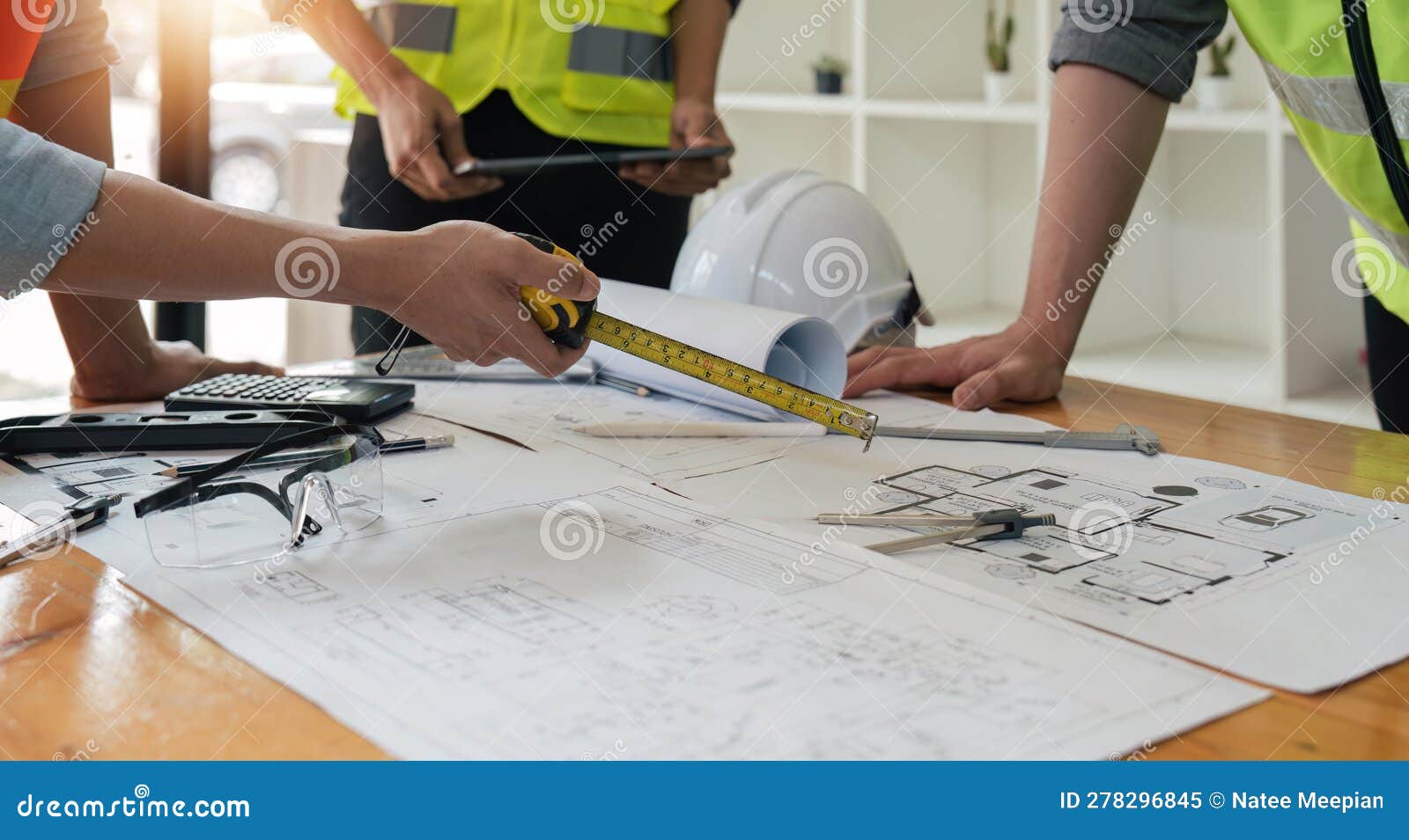Engineer People Meeting Working and Pointing at a Blueprint in Office ...