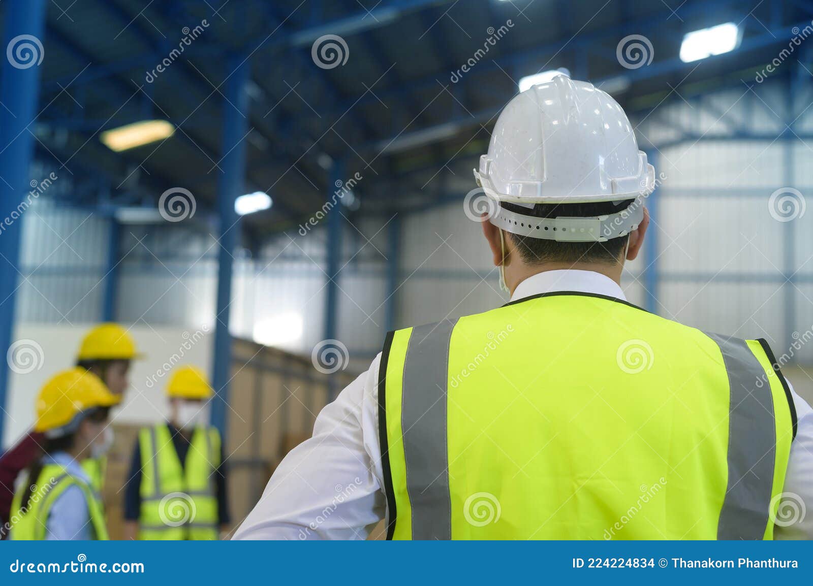 Engineer People are Putting a Protective Helmet on Head in Warehouse ...