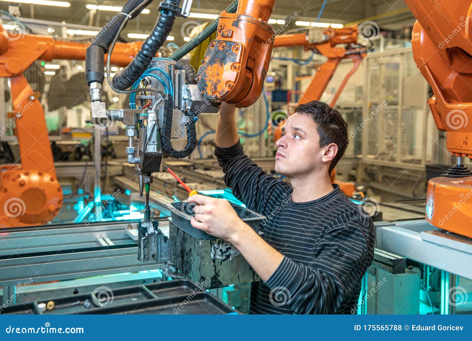 Engineer Performs Maintenance of Industrial Robot in a Factory Stock ... Engineer Performs Maintenance of Industrial Robot in a Factory Stock ...