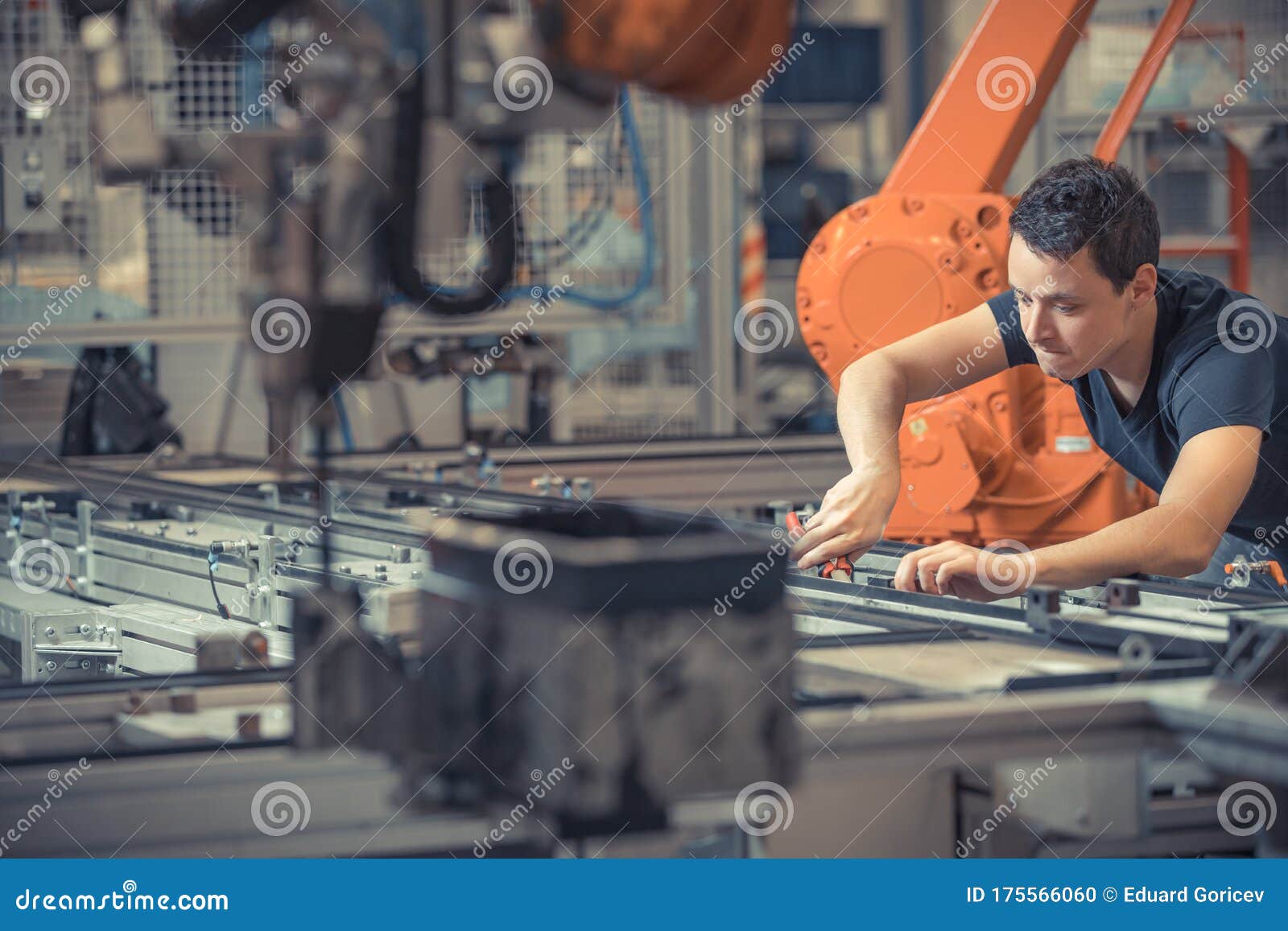 Engineer Performs Maintenance of Industrial Robot in a Factory Stock ... Engineer Performs Maintenance of Industrial Robot in a Factory Stock ...