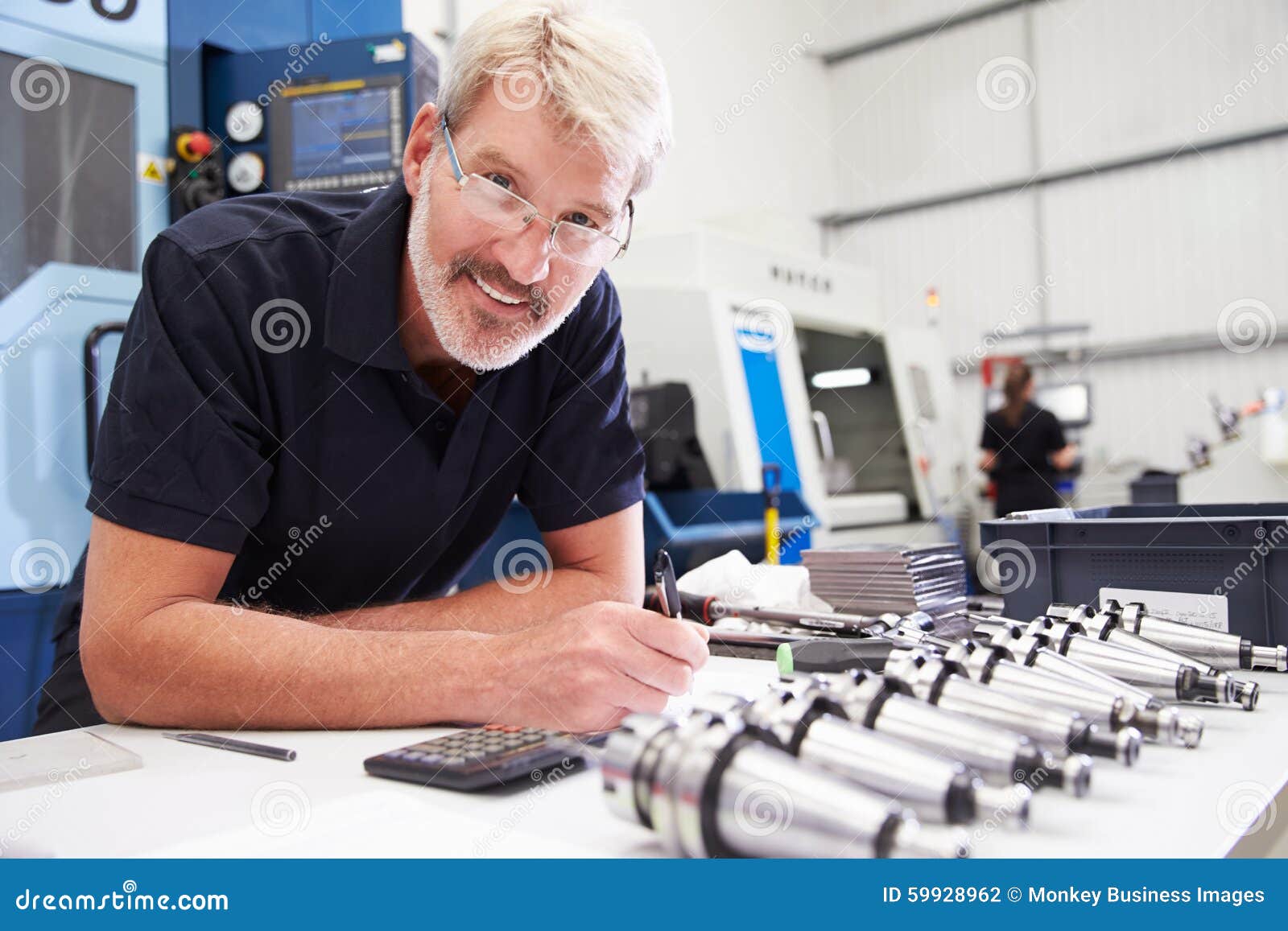 Engineer Planning Project with CNC Machinery in Background Stock Photo ...