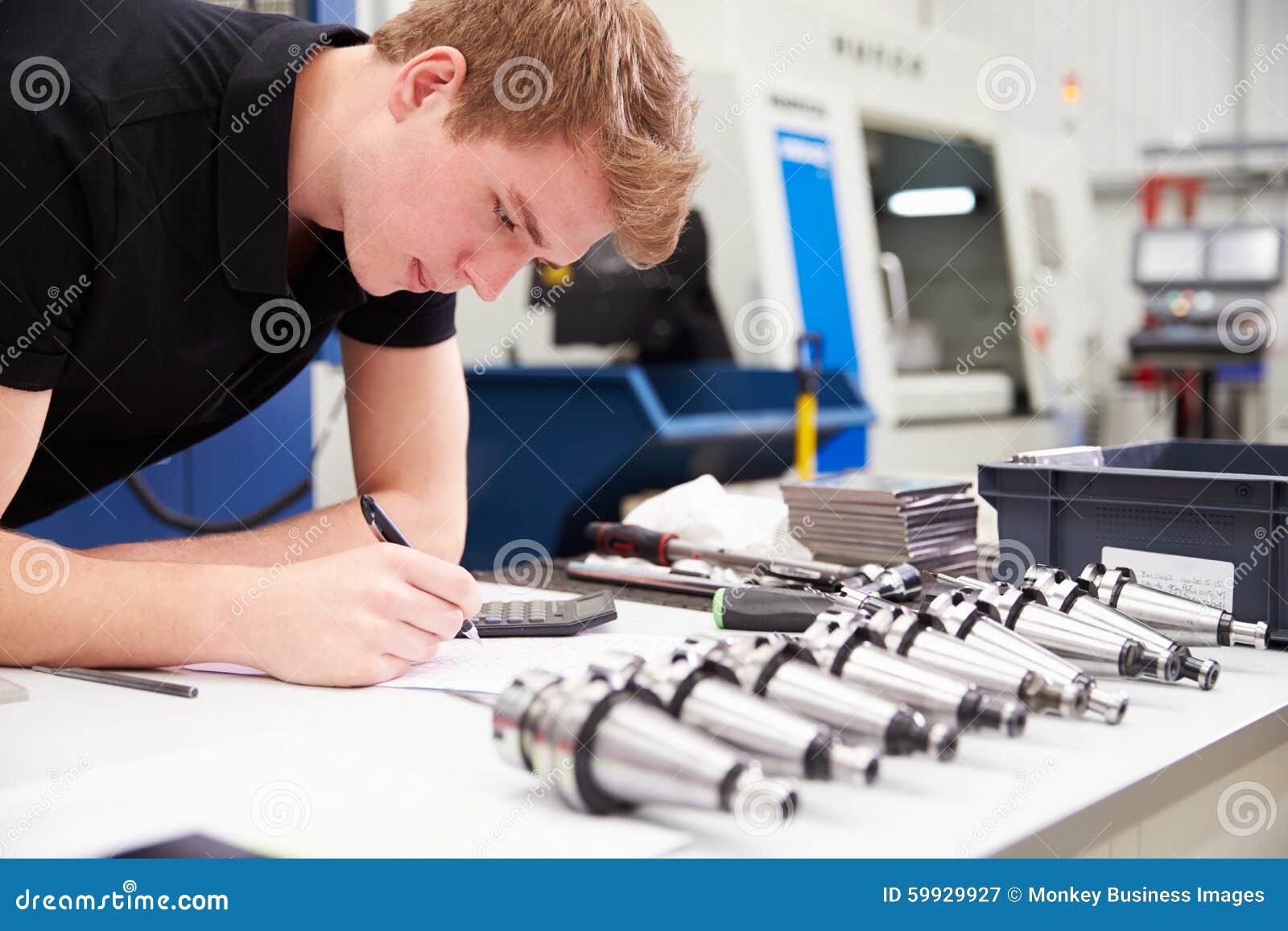 Engineer Planning Project with CNC Machinery in Background Stock Image ...
