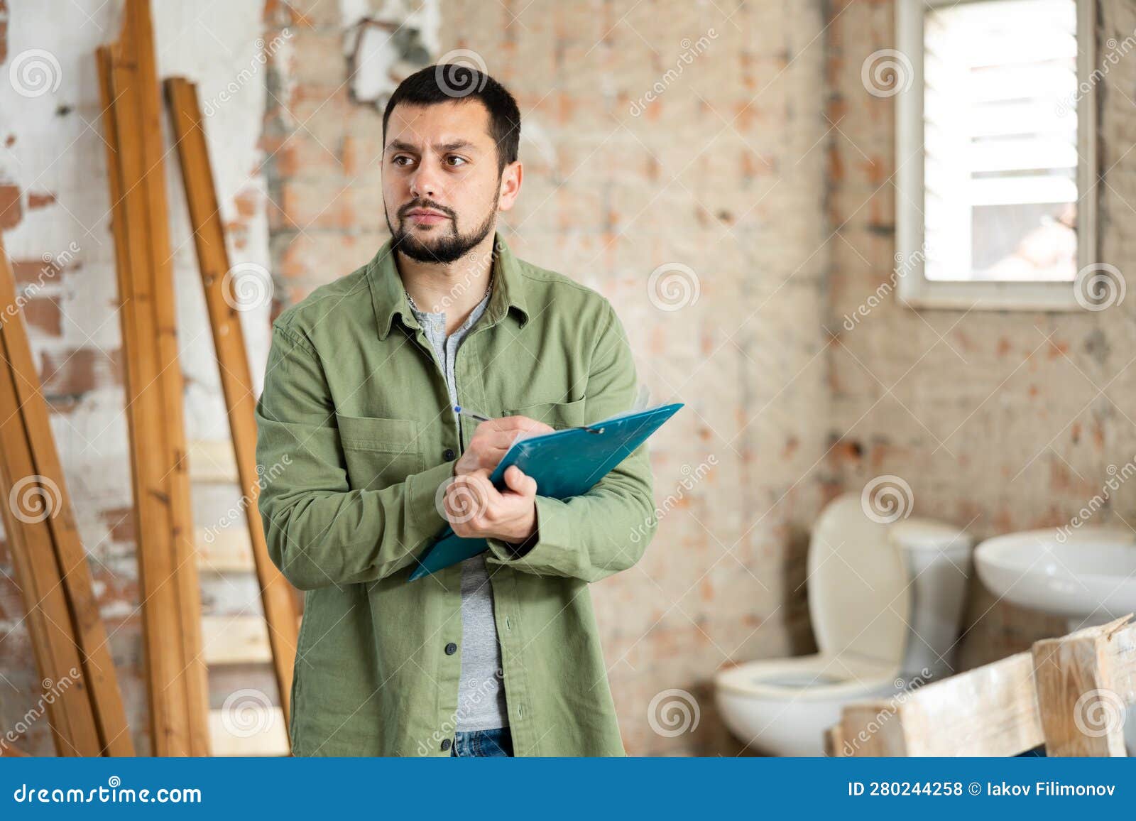Engineer Planning Renovation Works at Building Site, Looking at Papers ...