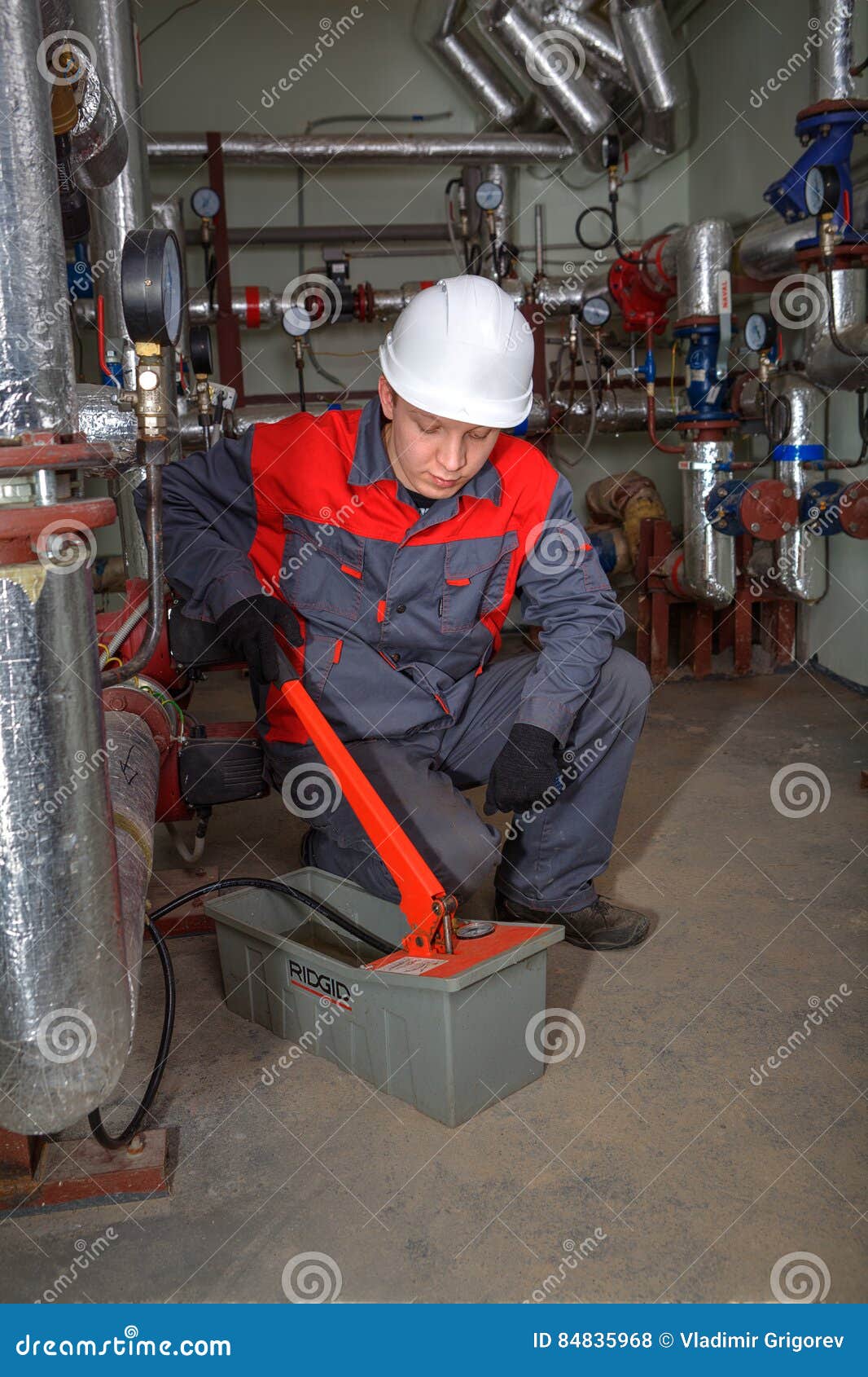 Engineer Plumbers Testing Central Heating System Using Pressure ...