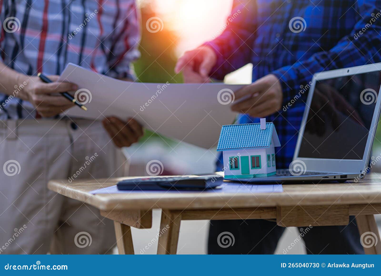 Engineer Pointing at Blueprint and Using Laptop To Draw Building Design ...