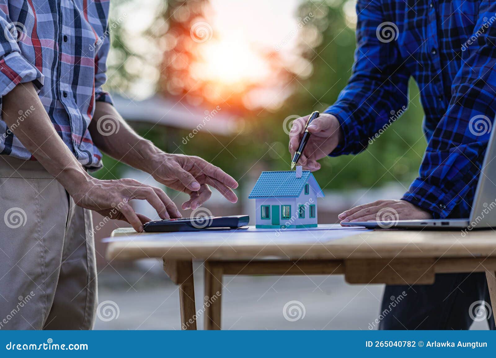 Engineer Pointing at Blueprint and Using Laptop To Draw Building Design ...