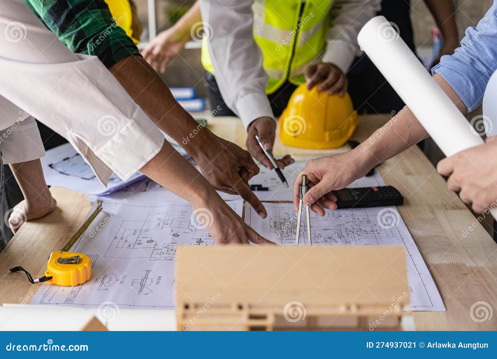 Engineer Pointing at Blueprint and Using Laptop To Draw Project Design ...