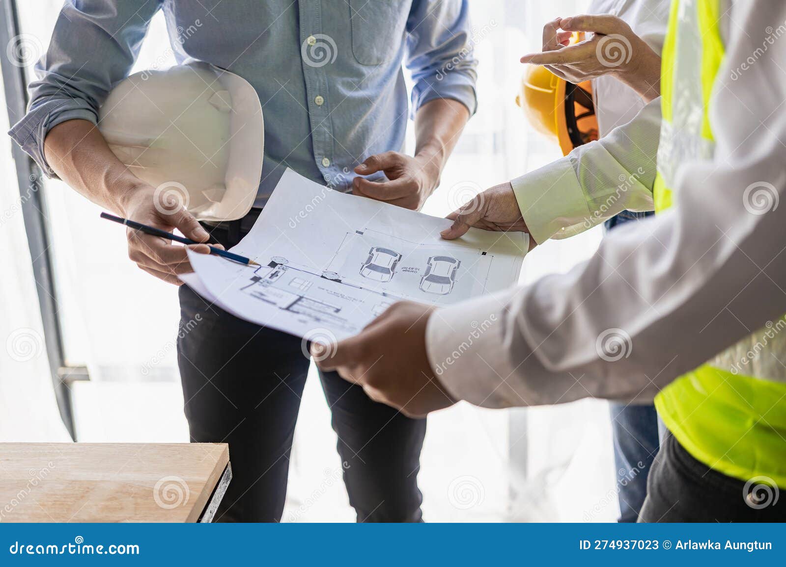 Engineer Pointing at Blueprint and Using Laptop To Draw Project Design ...