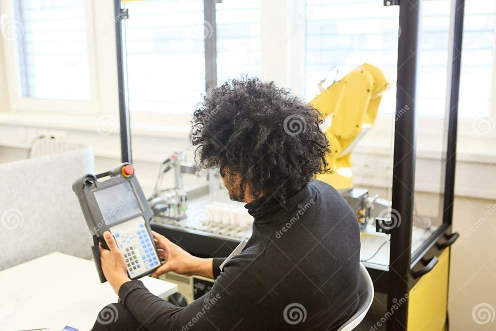 Engineer Programming Industrial Robot with Control Panel in Modern Lab ...